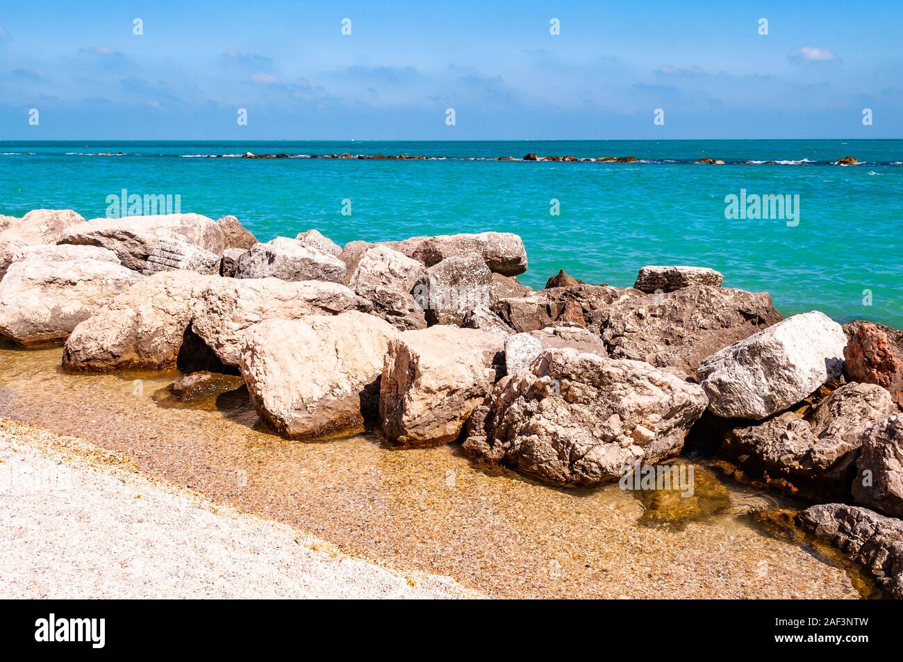 Massive stones rocks lying on the beach as a border between pebble ...