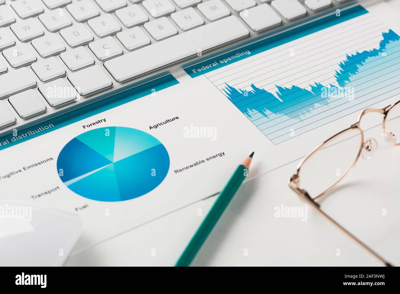 Business workplace with keyboard mouse and papers with graphs and ...