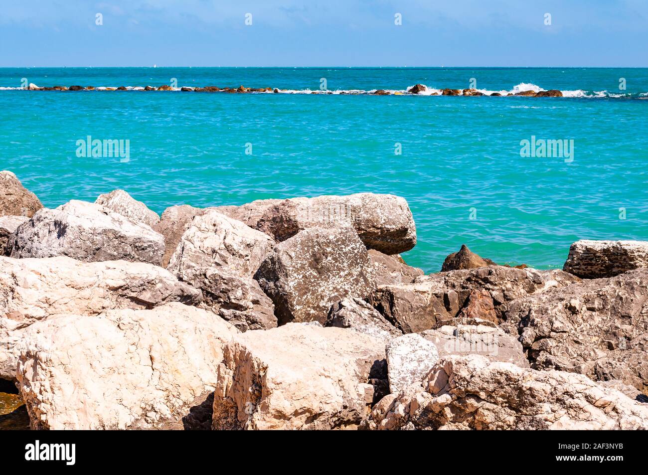 Massive stones rocks lying on the beach as a border between pebble ...