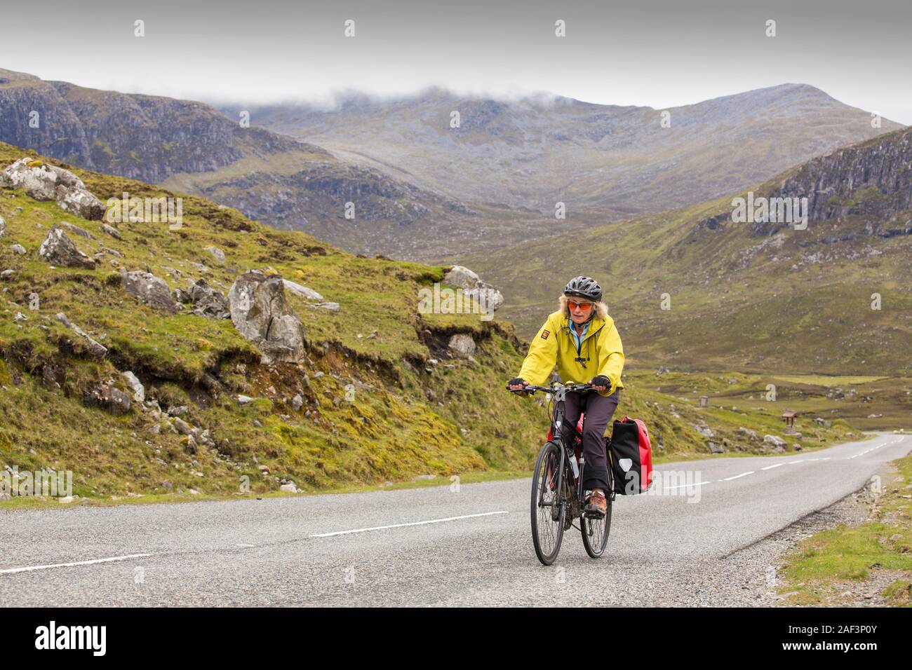 A woman cycle touring on the Isle of Harris, Outer Hebrides, Scotland ...
