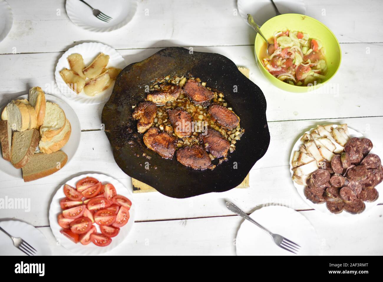 cooking meat. Pork chunks of meat are cooked on a bonfire on a disc ...