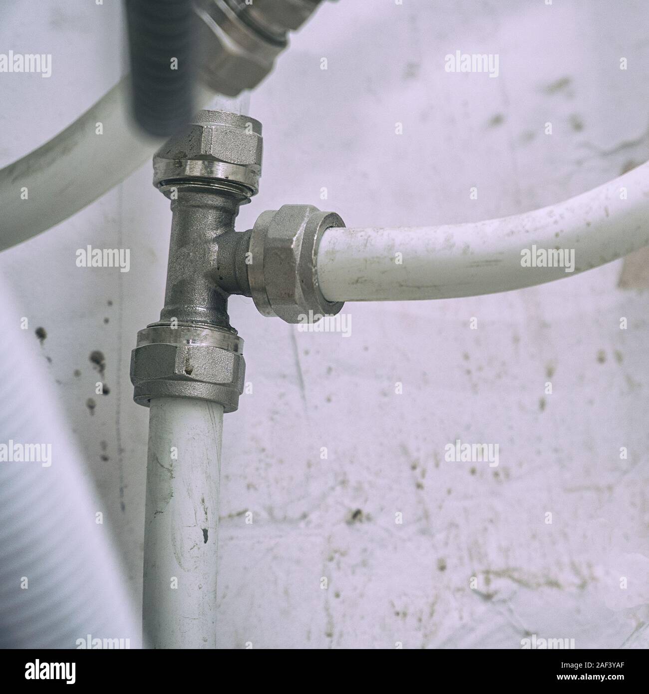 Old connection fitting tee on plastic water pipes Stock Photo - Alamy