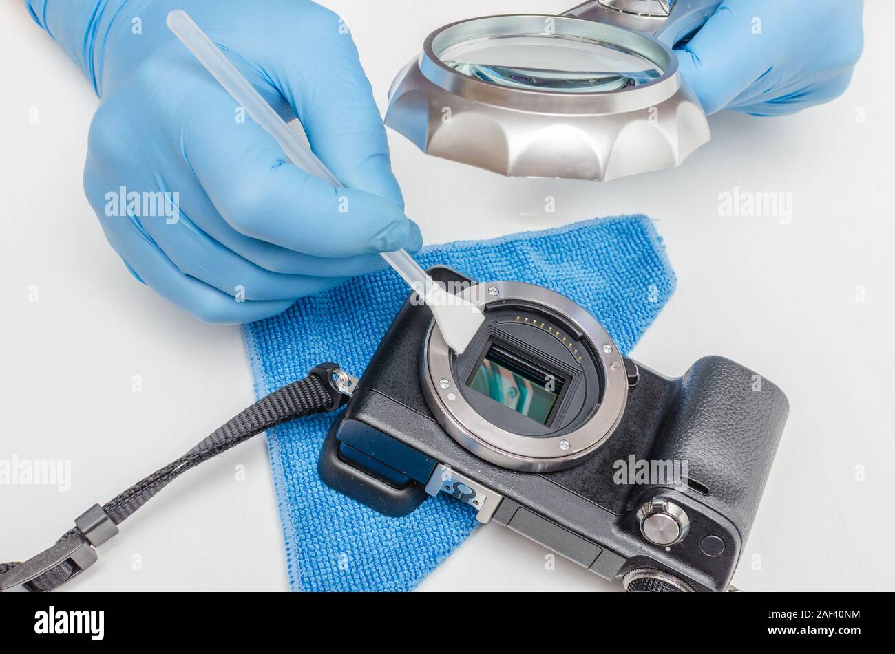 Cleaning the digital camera matrix. Digital camera service. The master ...