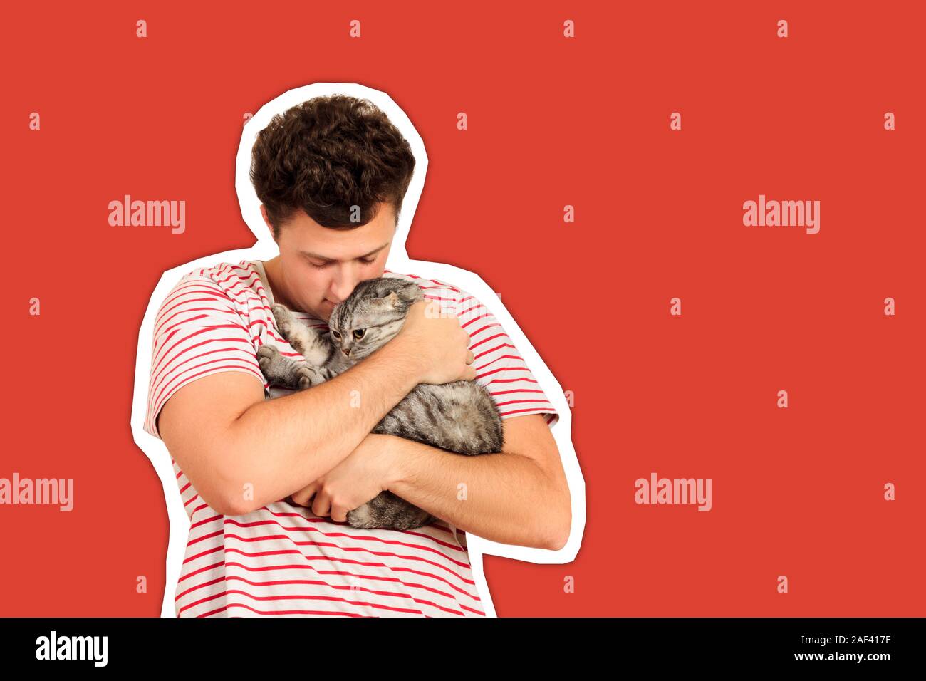 A cat and a man, a portrait of a happy cat with close eyes and a young ...