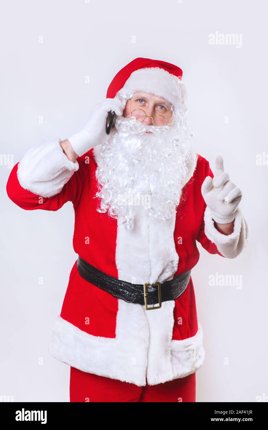 Santa Claus calling phone on white background Stock Photo - Alamy