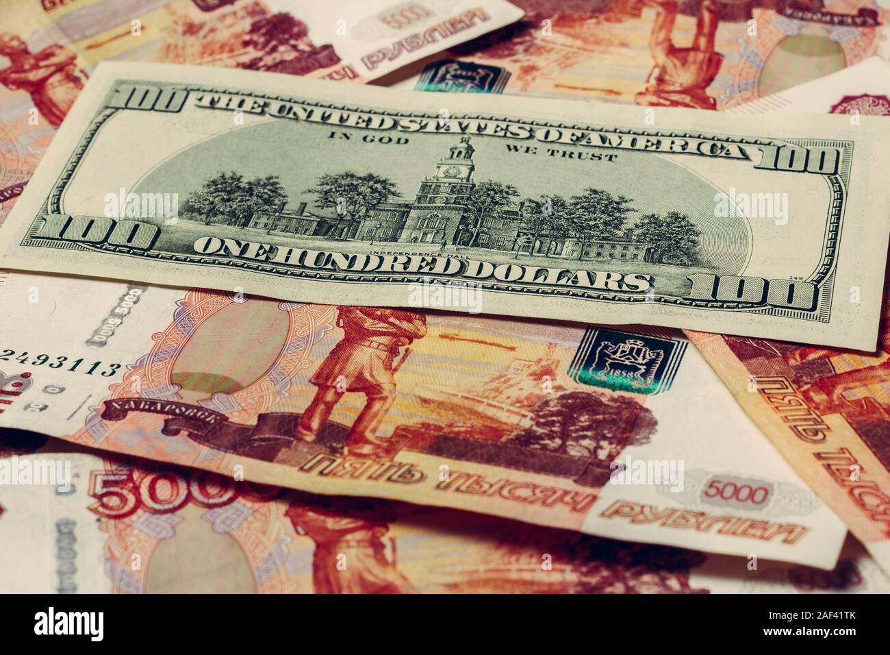 one hundred dollar bill lies on 5000 Russian rubles, the side where the ...