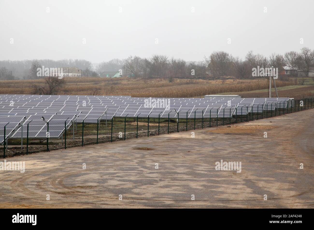 Solar panels near a rural road. Solar panel produces green ...