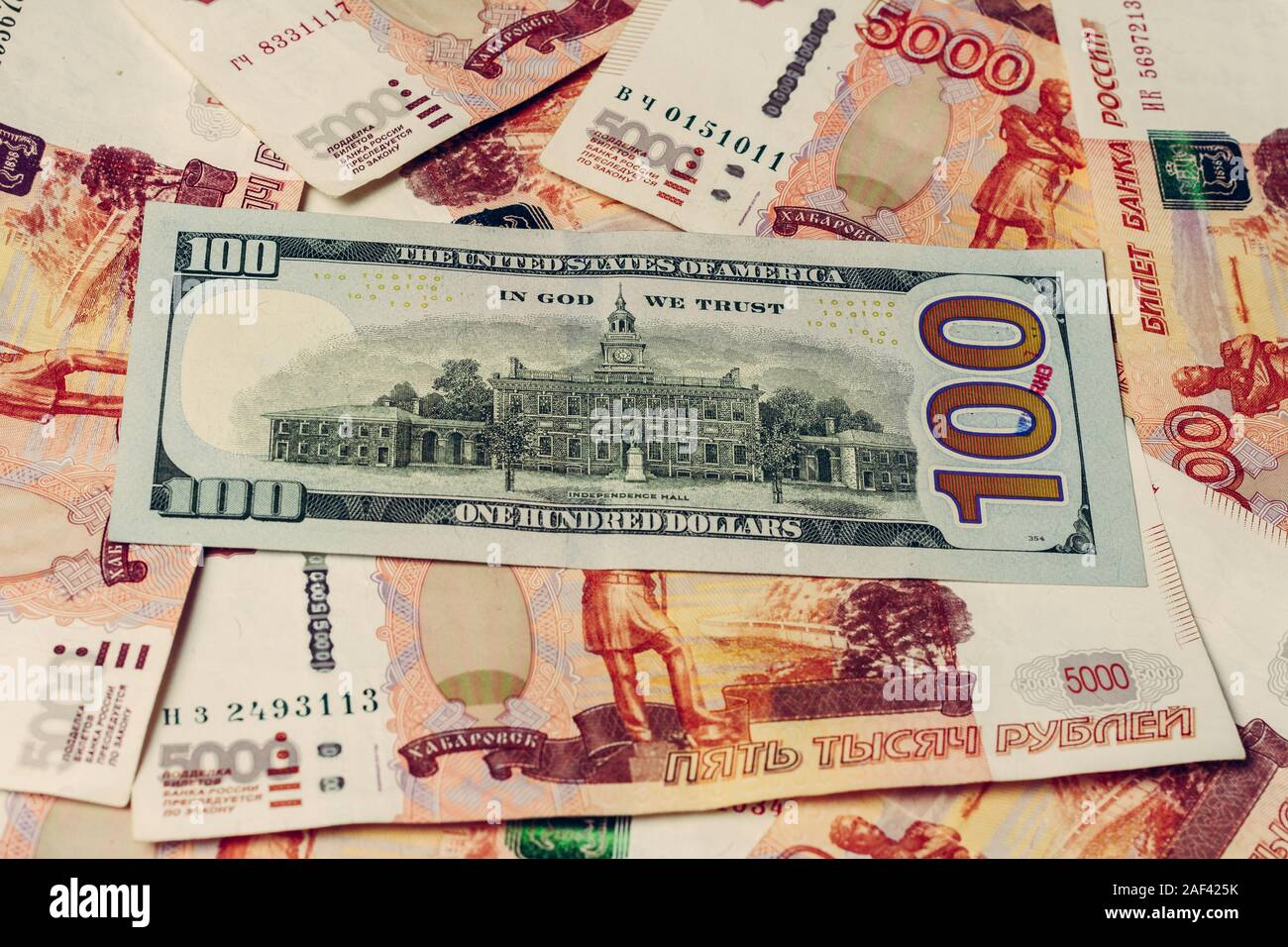 one hundred dollar bill lies on 5000 Russian rubles, the side where the ...