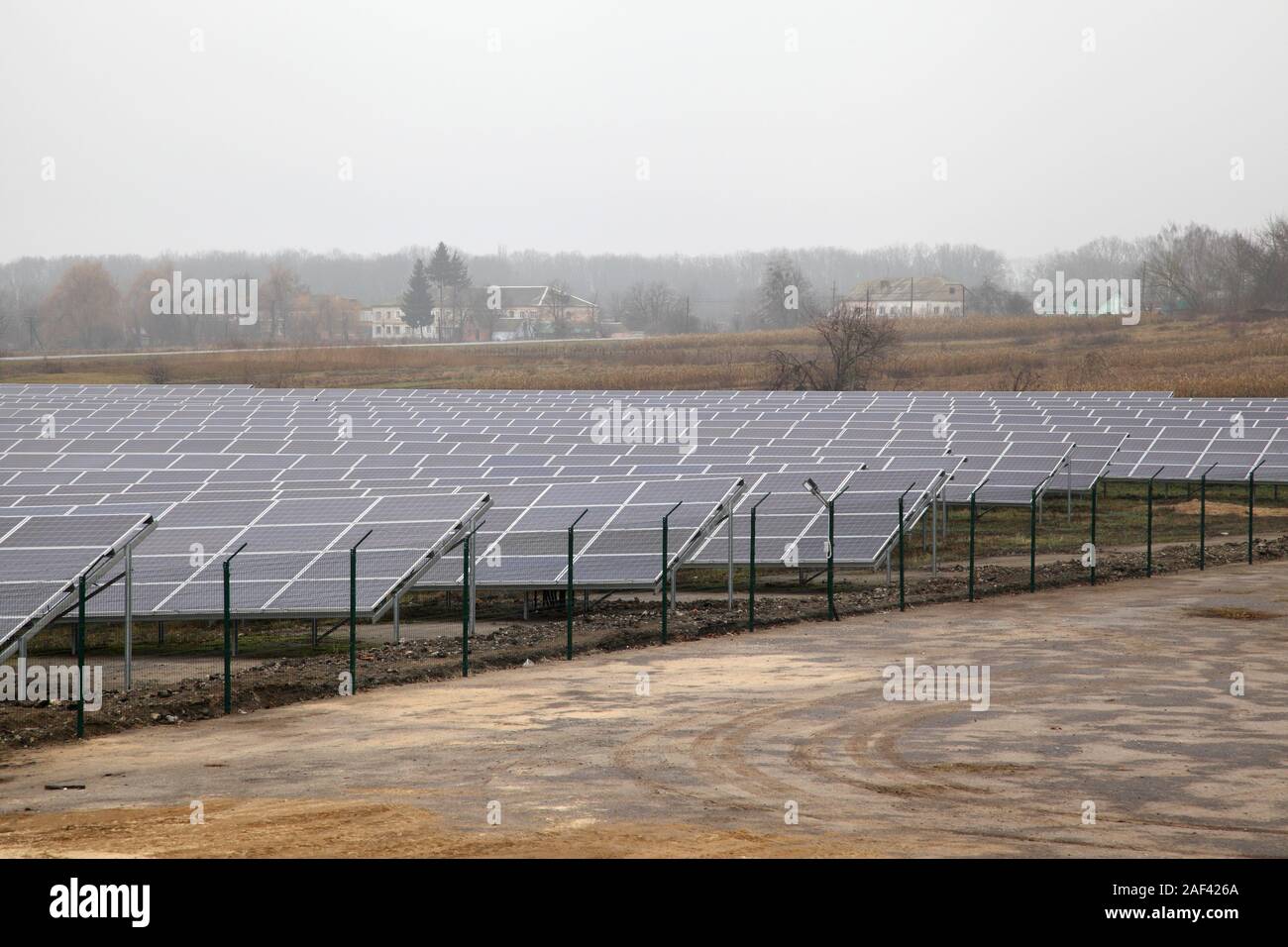 Solar panels near a rural road. Solar panel produces green ...