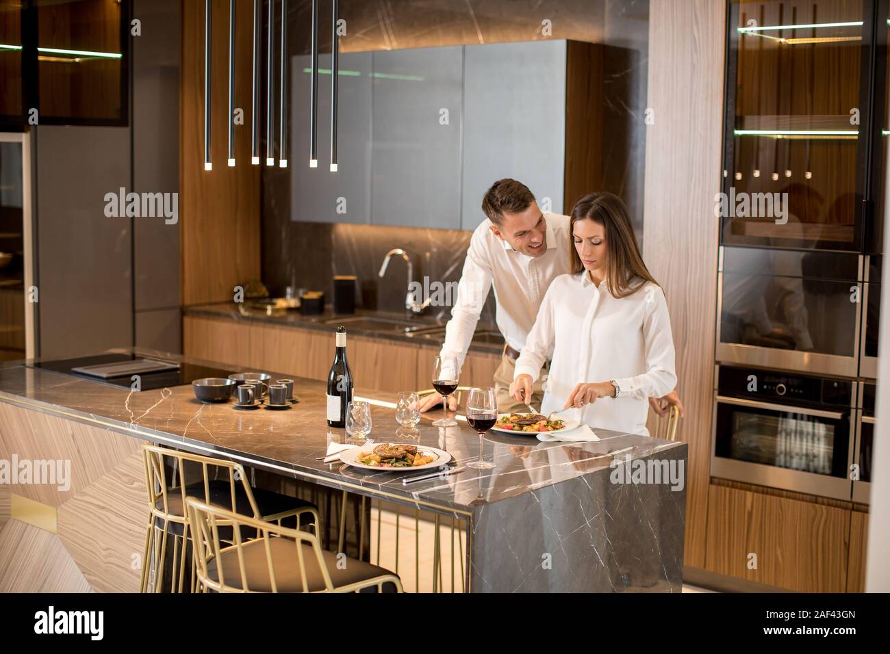 Sweet young couple having a romantic dinner at luxury kitchen Stock ...