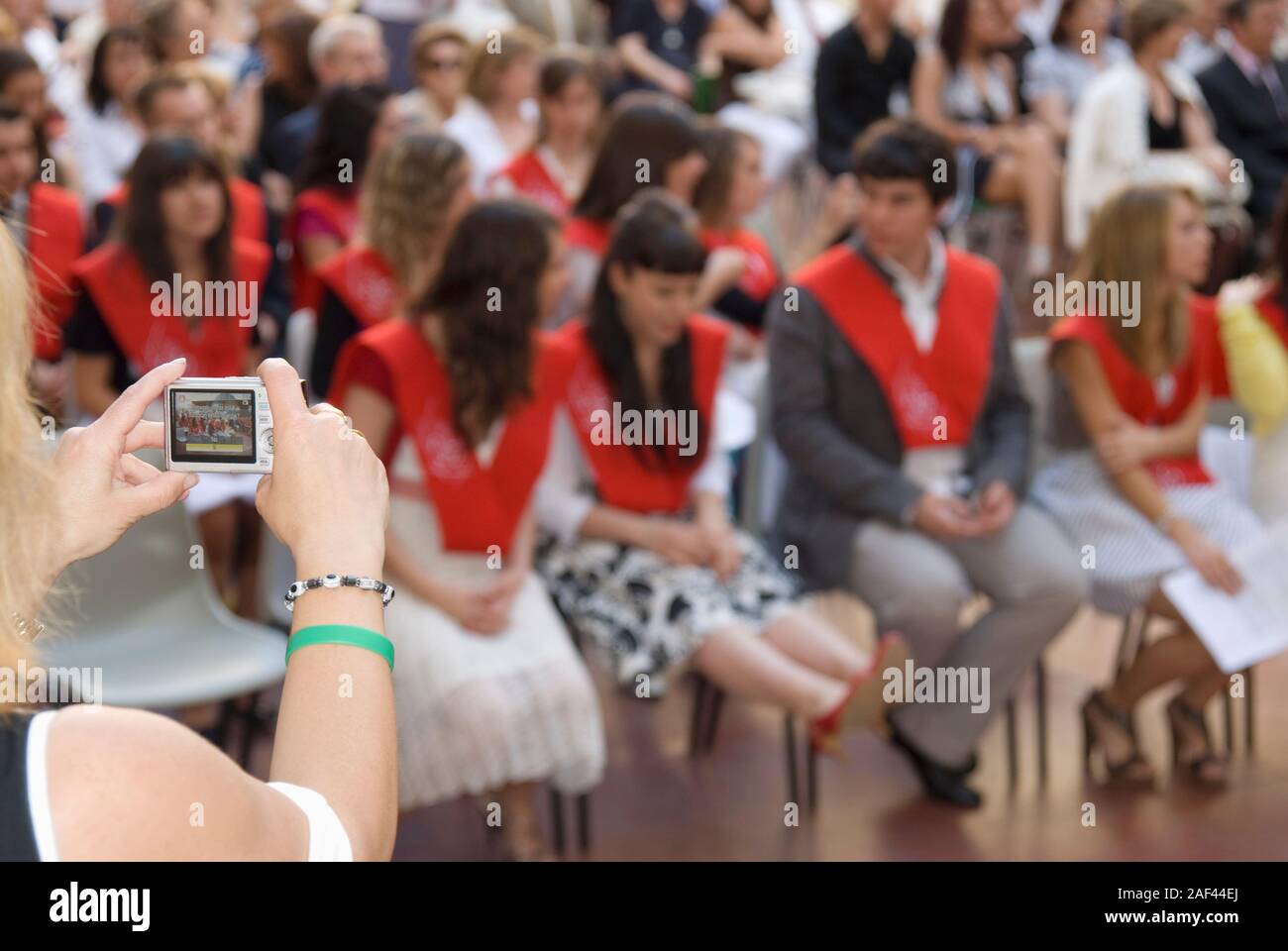 Woman taking photos in graduation ceremony Stock Photo - Alamy