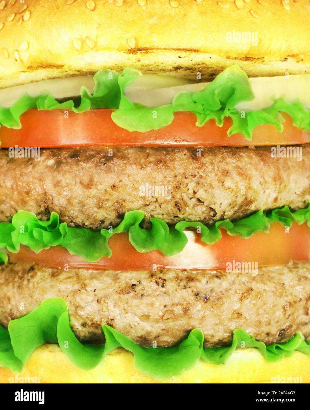 Over sized stack of beef burgers with salad filling Stock Photo - Alamy