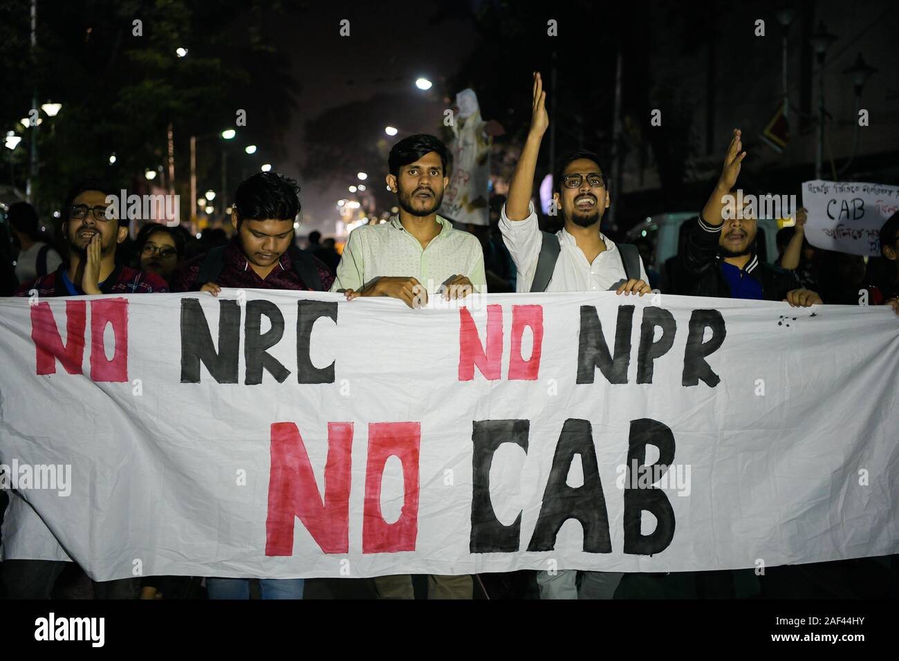 Protesters shouting slogans while holding a banner during the ...