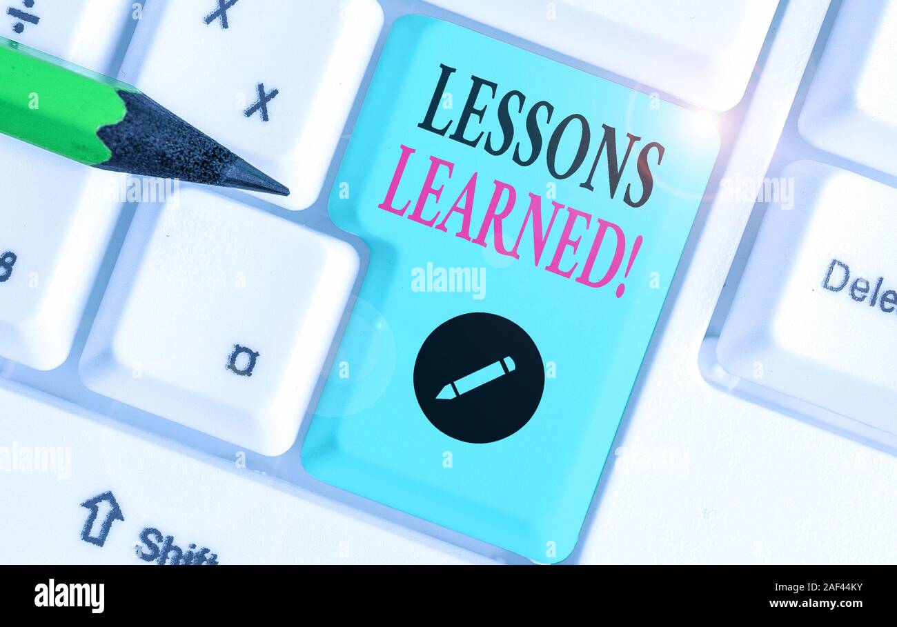 Writing note showing Lessons Learned. Business concept for experiences distilled project that ...