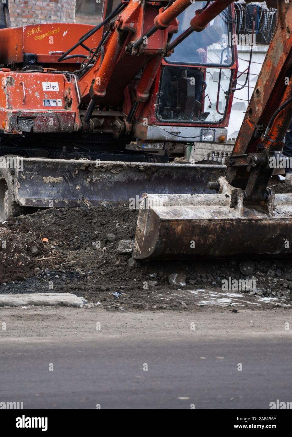Orange excavator works on construction site with a gravel and carry it ...