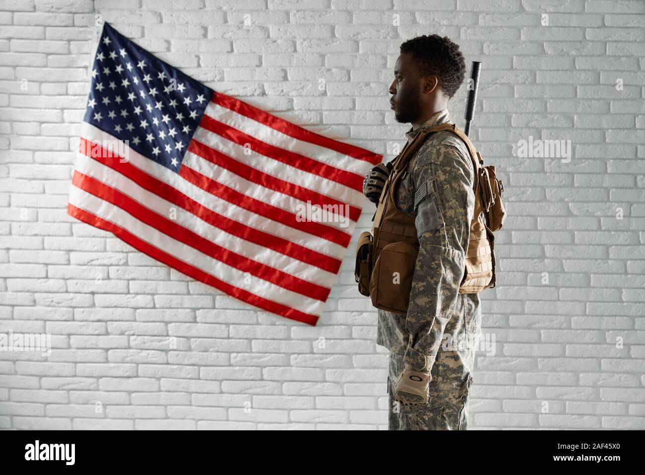 Side view of American soldier wearing uniform turning and standing near ...