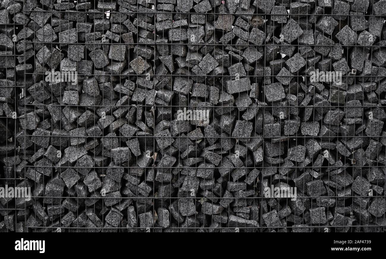 A stone wall that uses metal and stone in harmony. Ecology friendly ...