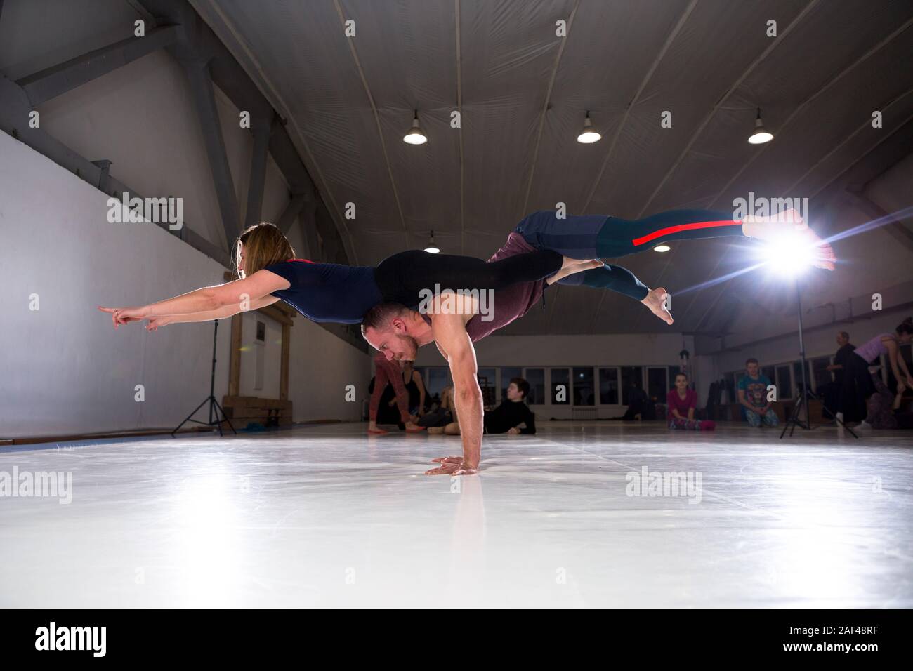 Strong acrobatic woman lifting man hi-res stock photography and images ...