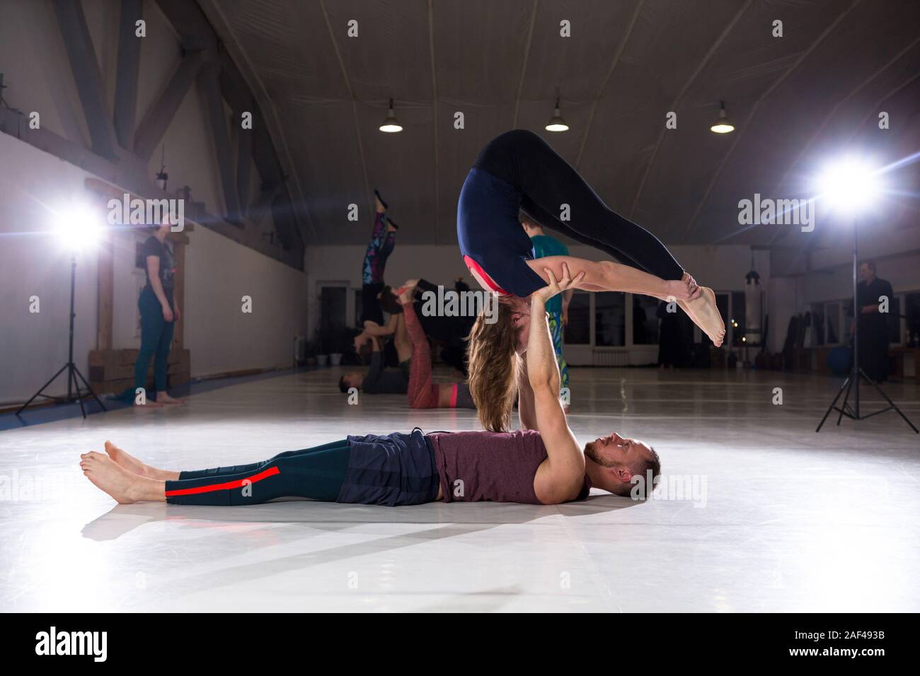 Couple does acroyoga, physical practice yoga and acrobatics. Balance ...