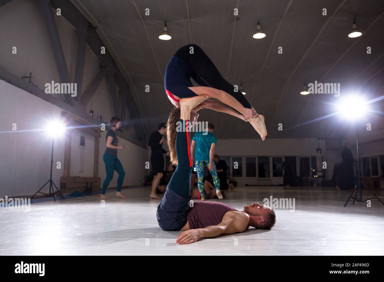 Couple does acroyoga, physical practice yoga and acrobatics. Balance ...