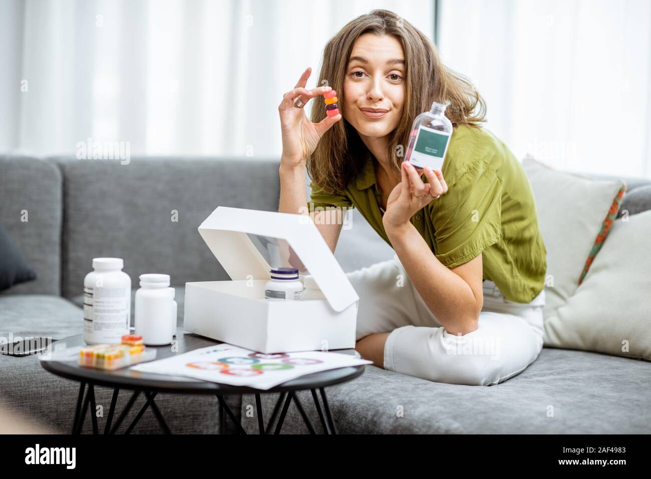 Woman taking supplements happy hi-res stock photography and images - Alamy