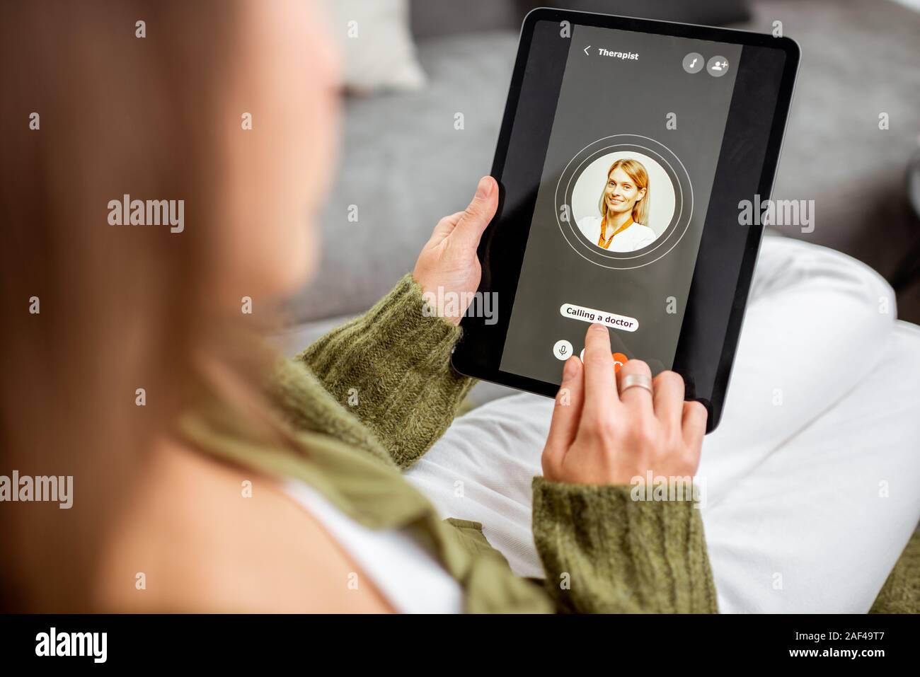 Woman making video call to a doctor using digital tablet, feeling bad ...