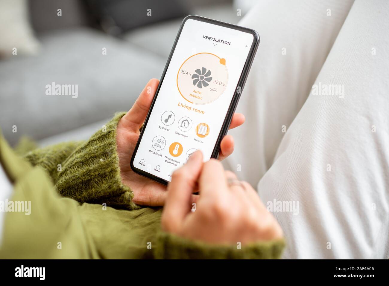 Controlling home conditioning with a smart phone, close-up. Concept of ...