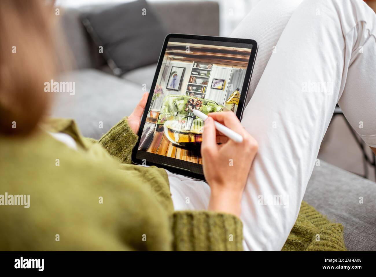 Artist or designer drawing interior sketch using digital tablet and ...