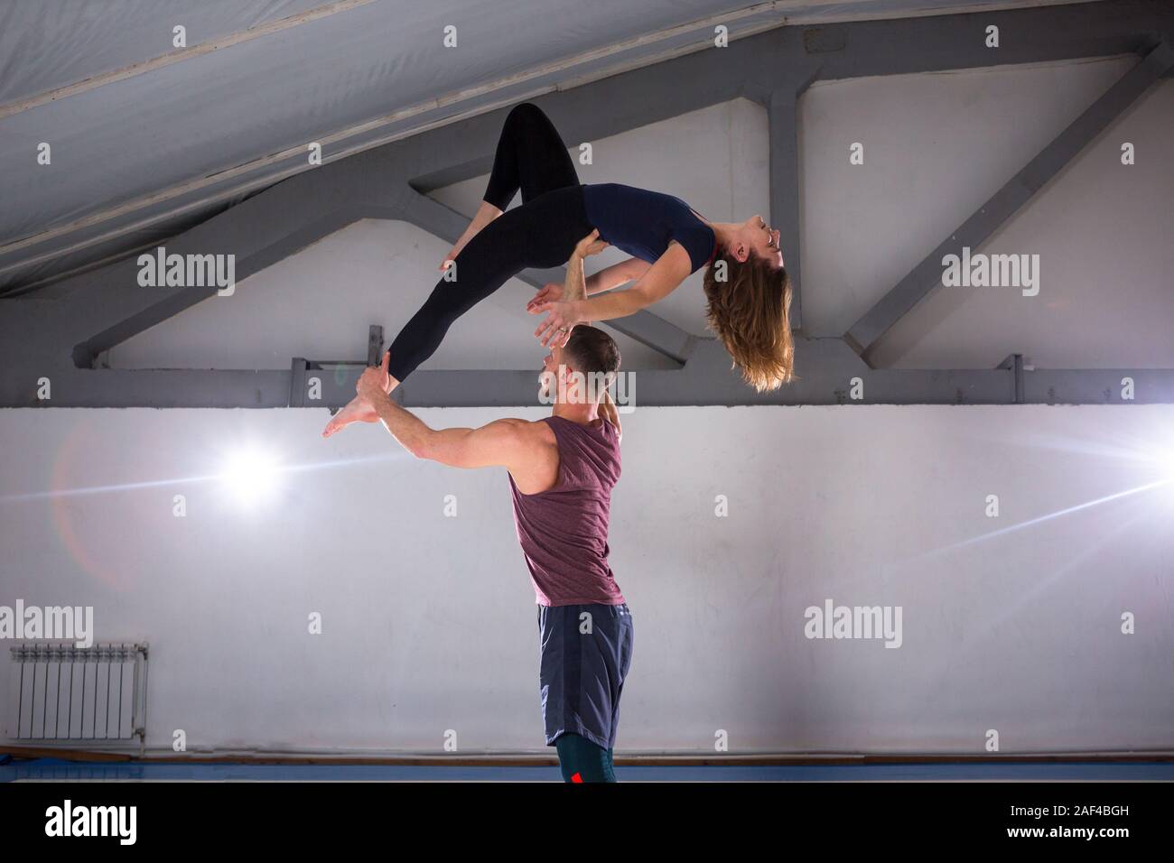 The theme of Acroyoga and Yoga Poses. A pair of two men and a woman ...