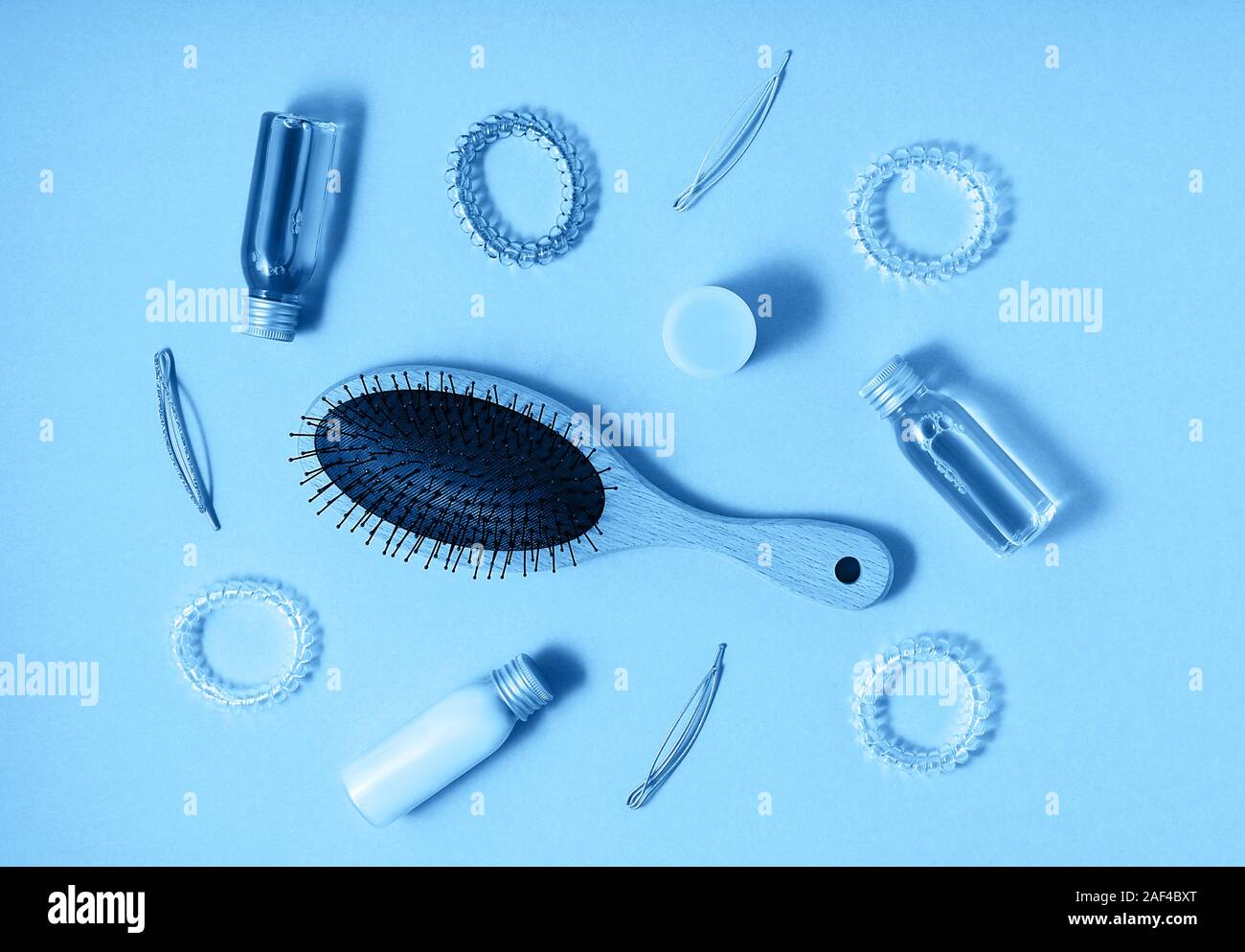Hair care products and styling items in trendy blue color. Flat lay ...