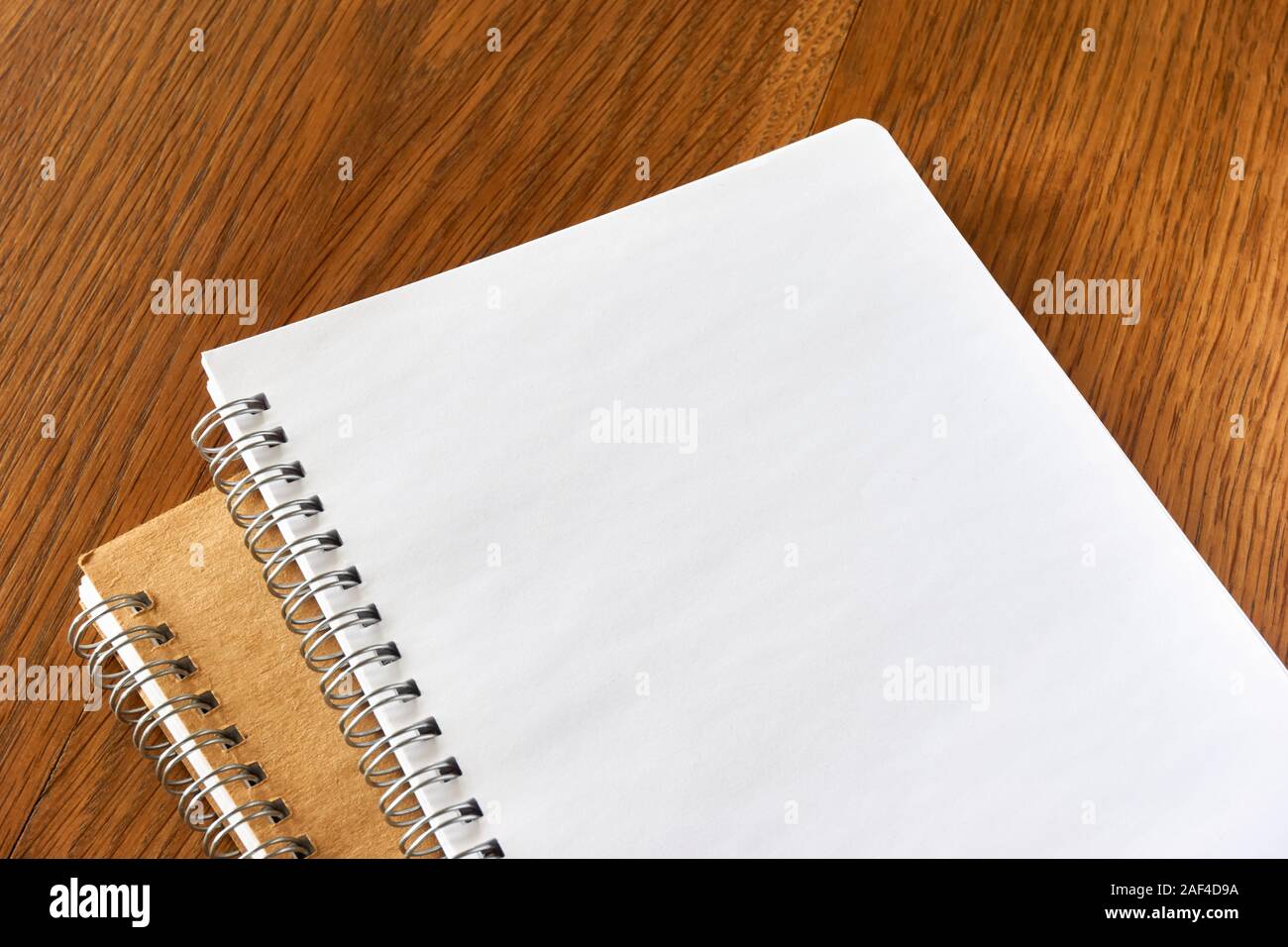 Top view detail of blank open notebook page with spiral ring on dark ...