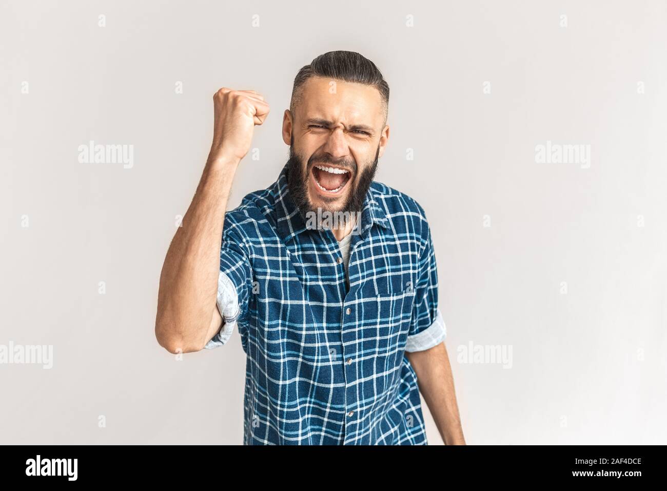 Mature bearded man scream, raised fist on hand Stock Photo - Alamy
