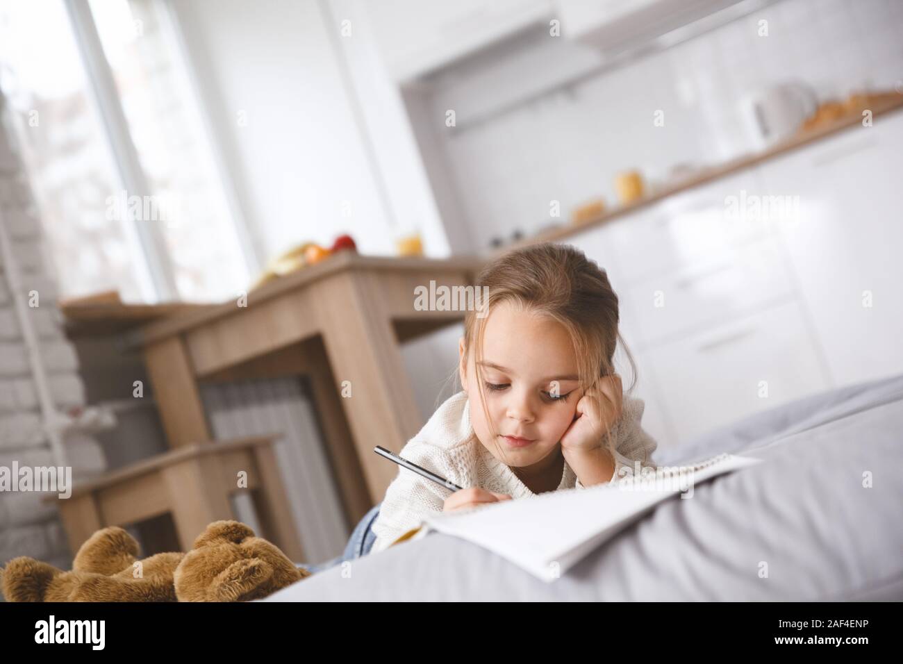 Little kid girl at home childhood concept doing homework Stock Photo ...