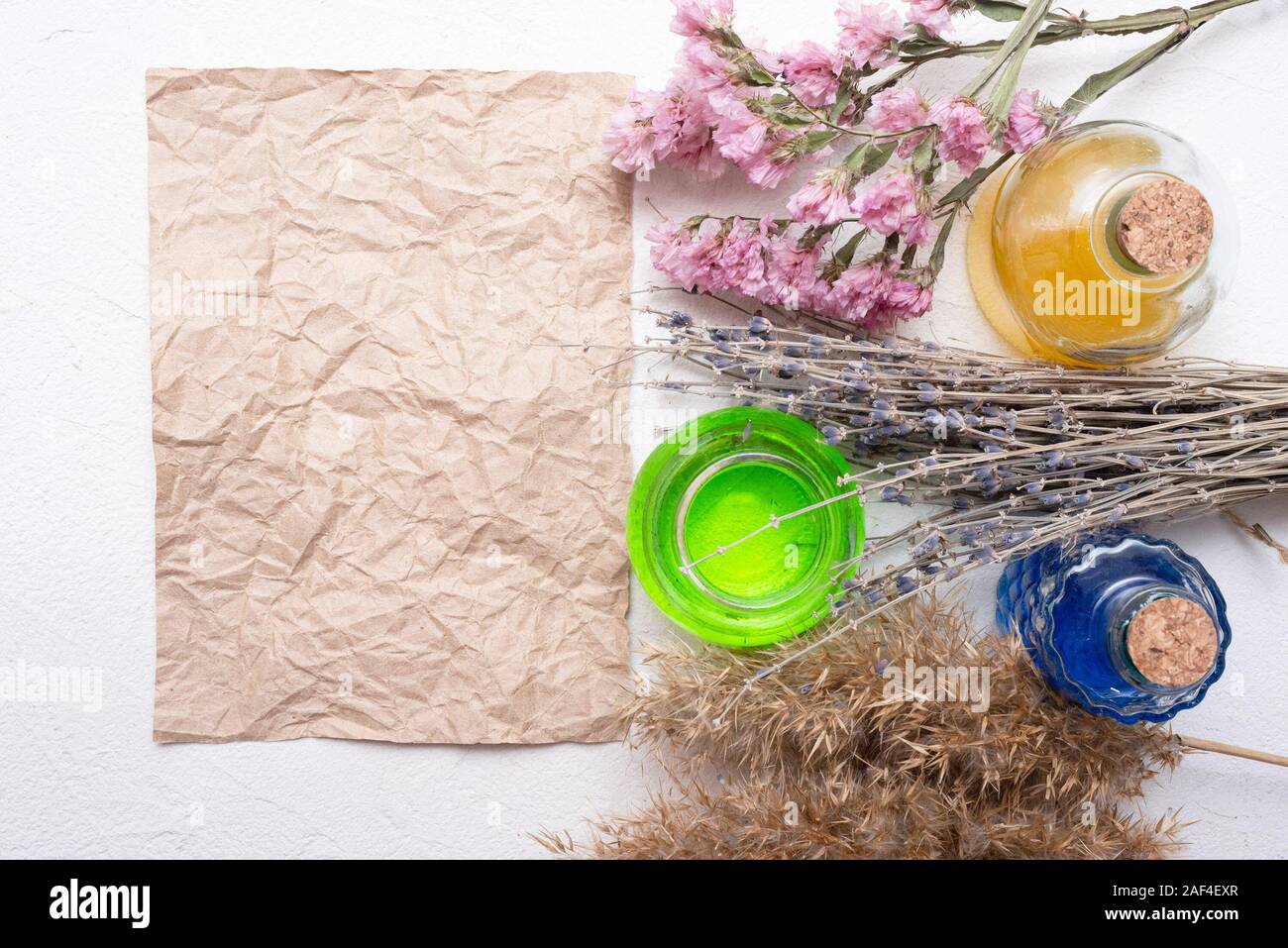Old magic scroll with copy space, dried herbs and bottles of magic ...