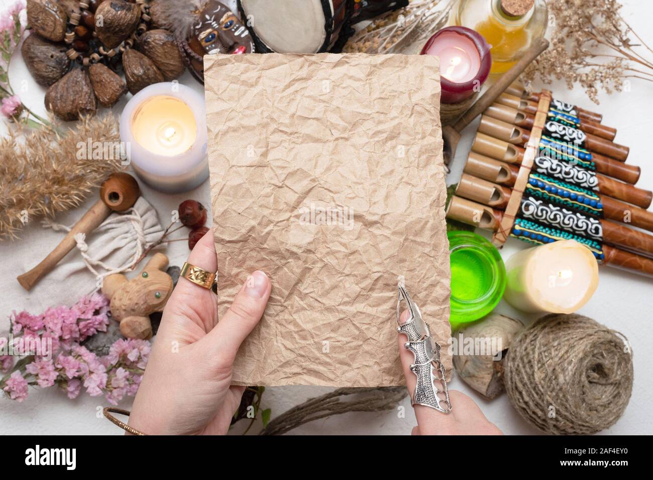 Witch doctor is reading an ancient magic scroll with copy space and ...