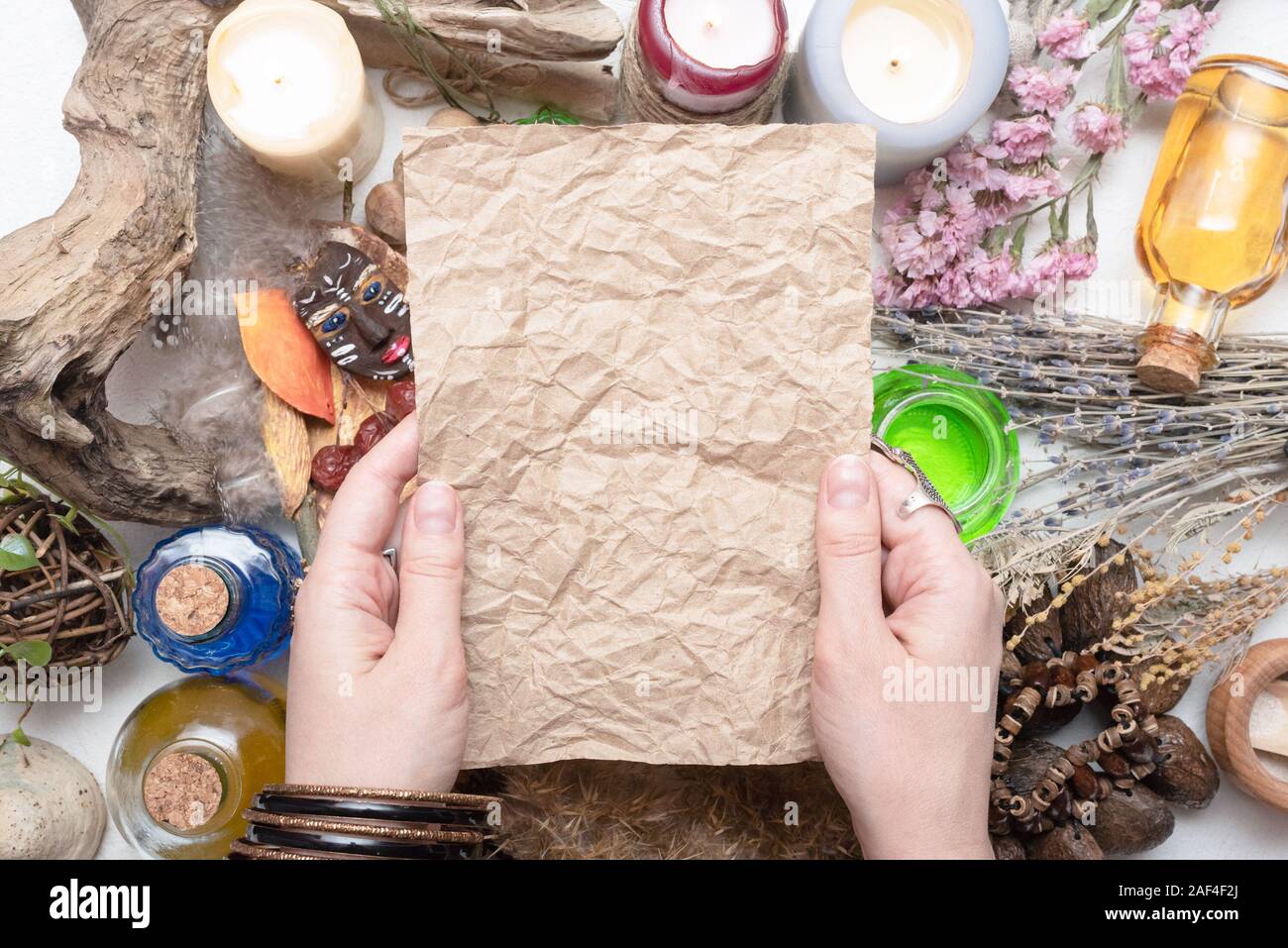 Witch doctor is reading an ancient magic scroll with copy space and ...