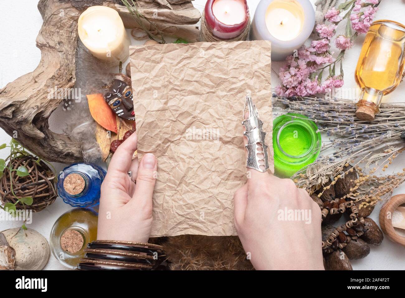 Witch doctor is reading an ancient magic scroll with copy space and ...