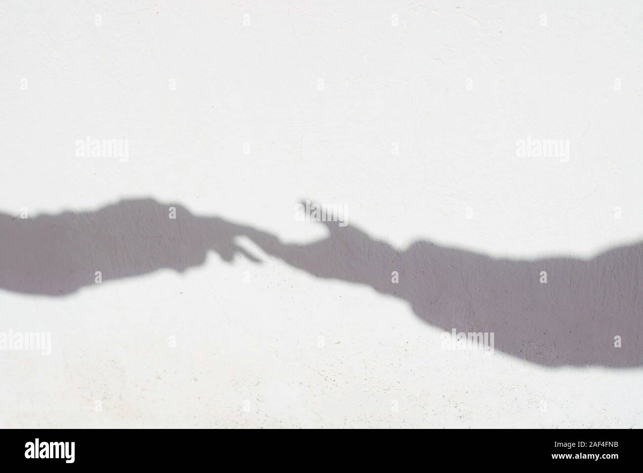 Two-handed shadow on a white background. Concept of Union and Love ...