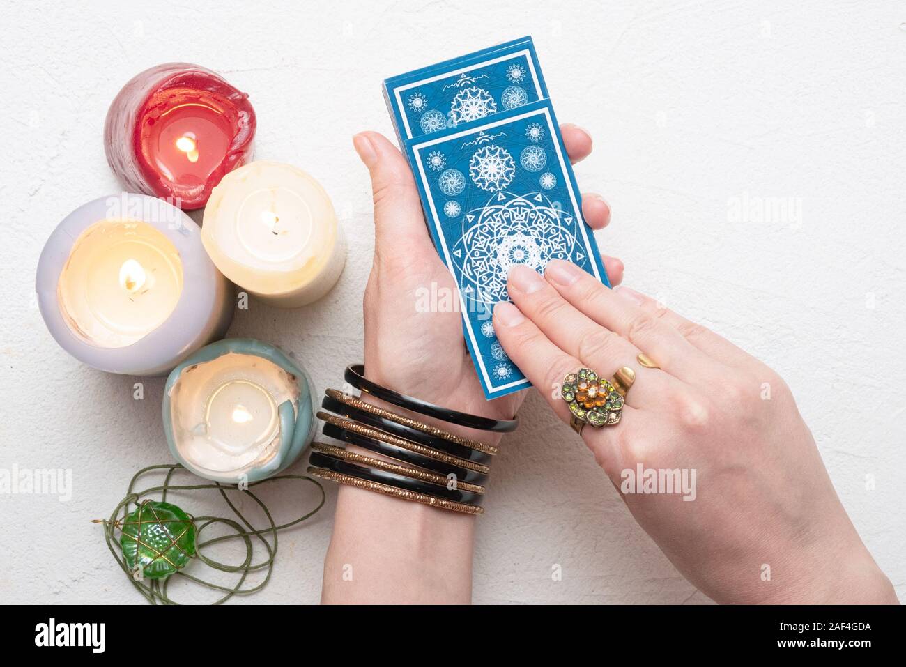 Fortune teller reading future on tarot cards over white table ...