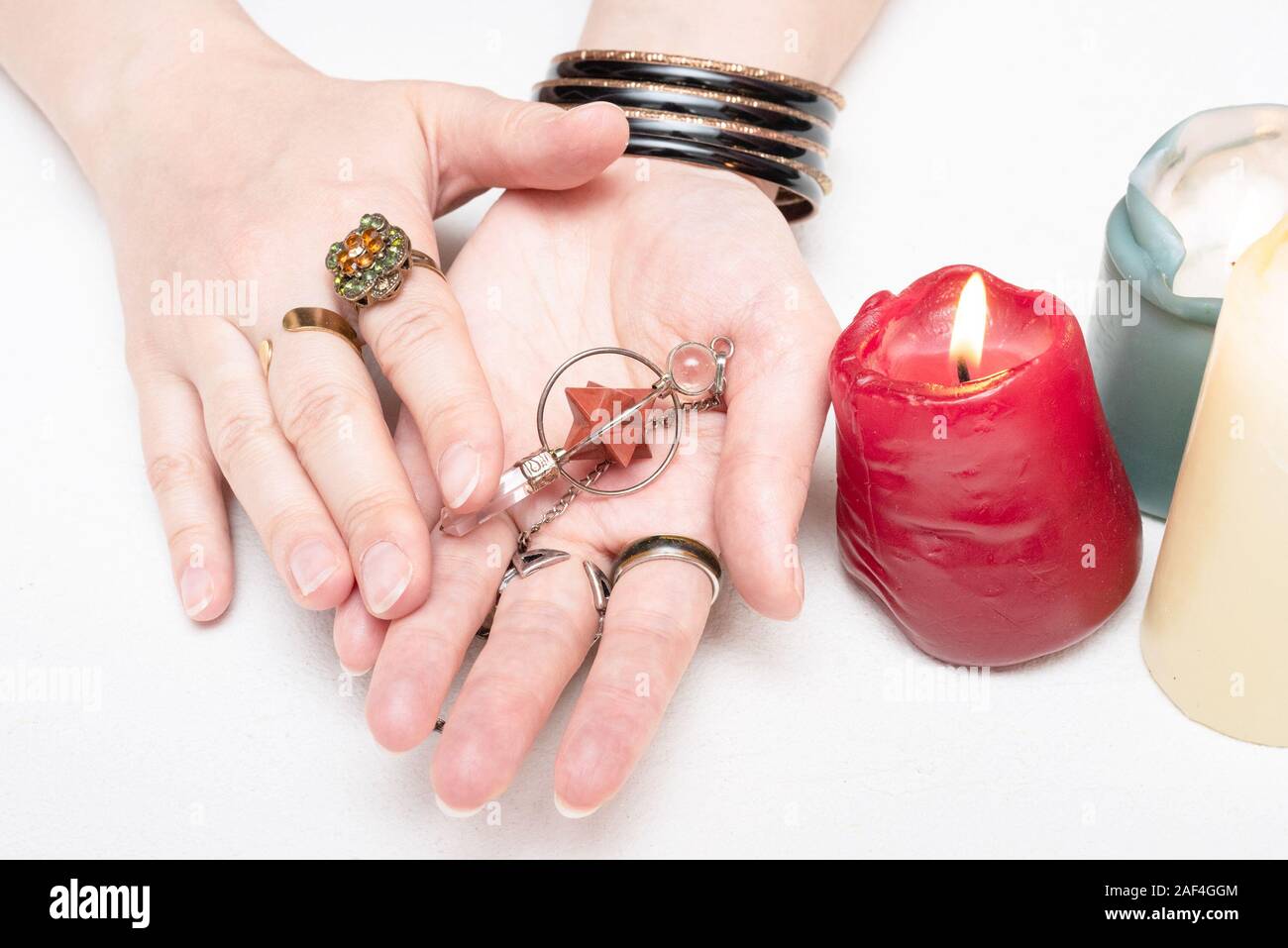 Fortune teller holding in hands a magic pendulum close up Stock Photo ...