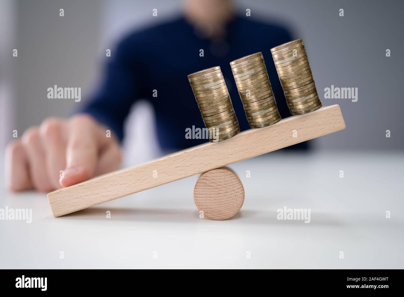 Balance scales with coins hi-res stock photography and images - Alamy