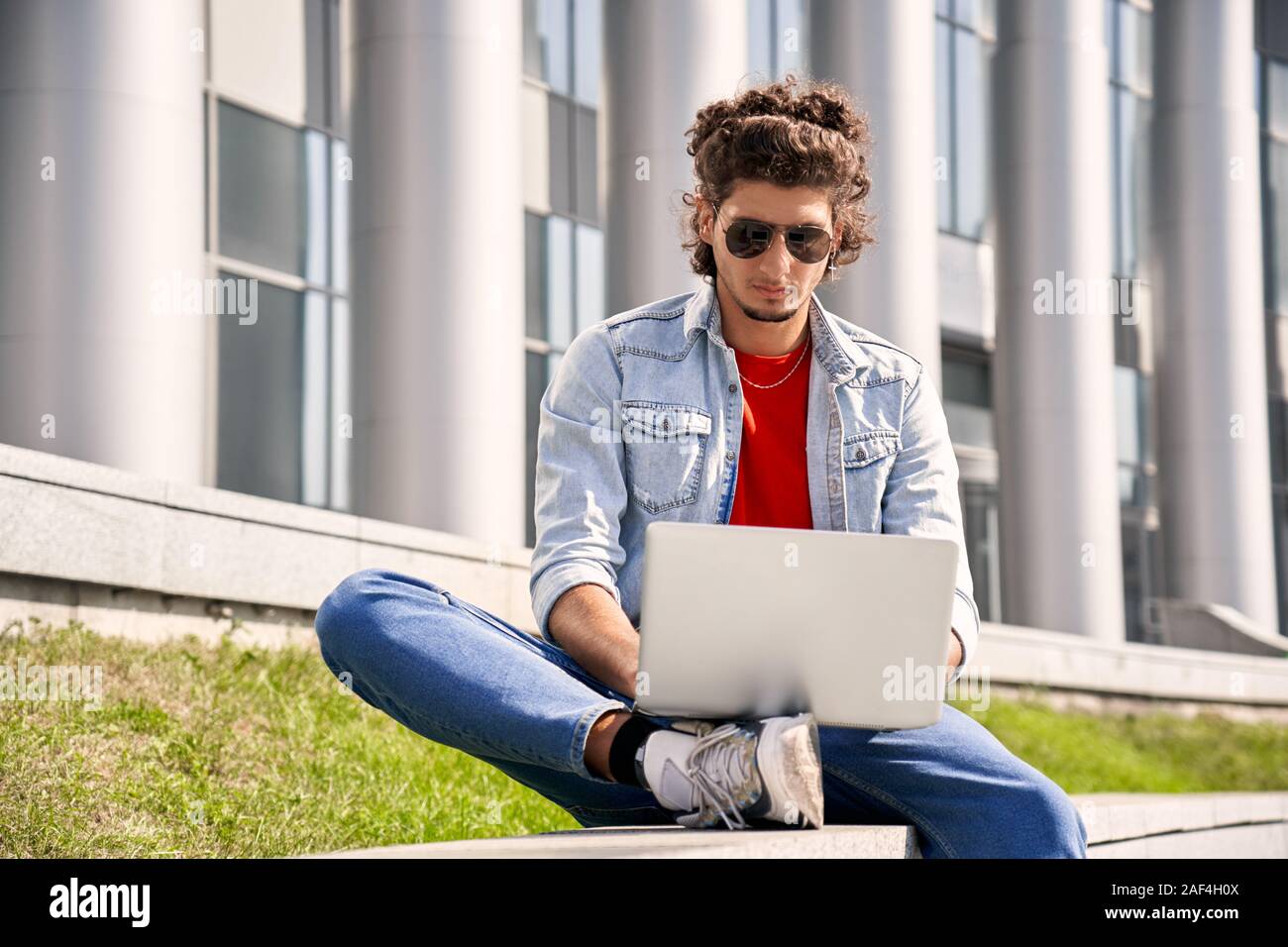 Young adult guy using modern laptop computer Stock Photo - Alamy