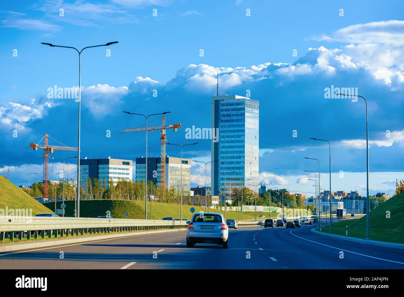 Car on road and Corporate business offices in street Stock Photo - Alamy