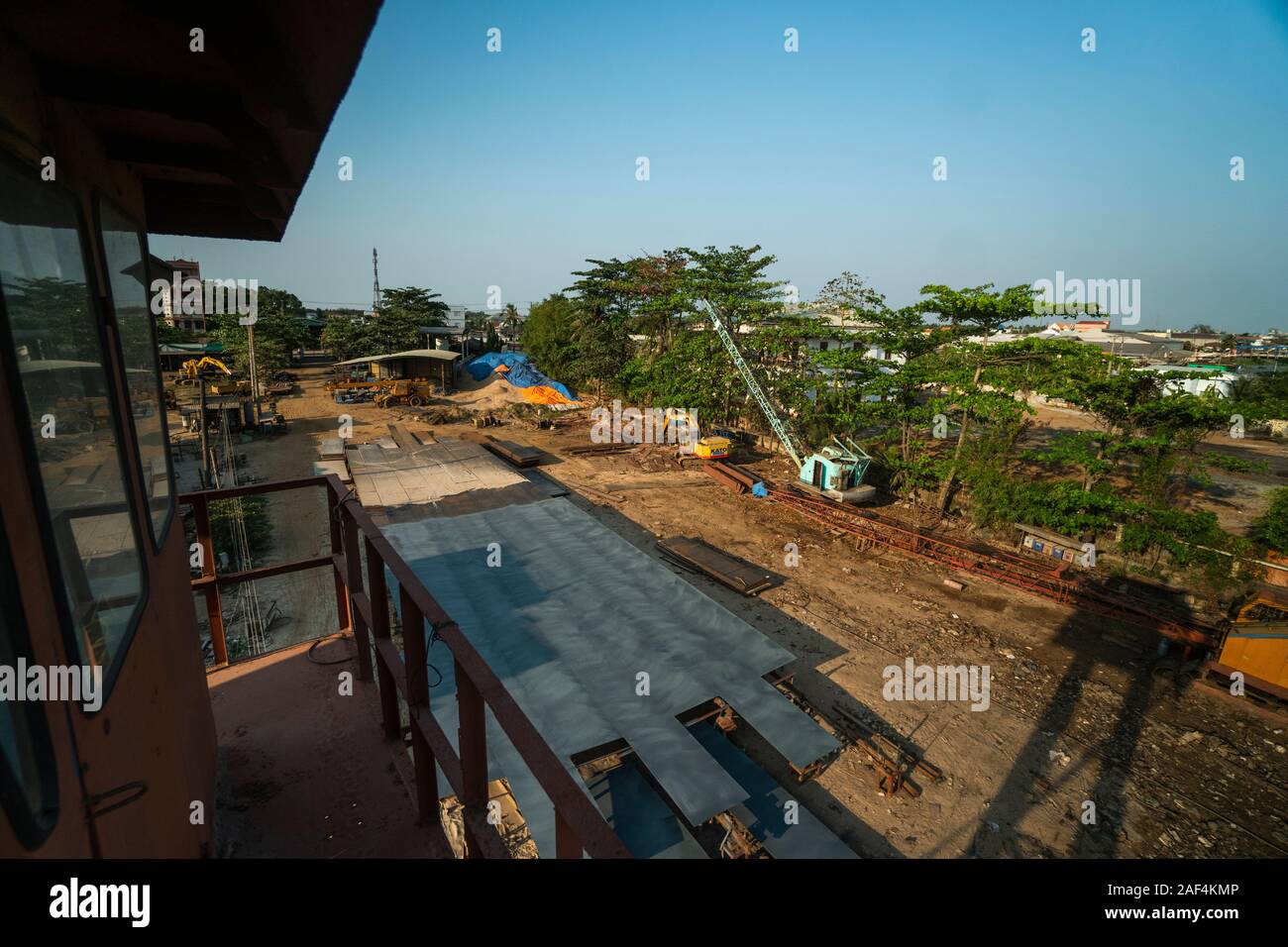 Automobile crane with risen telescopic boom and excavator outdoors ...