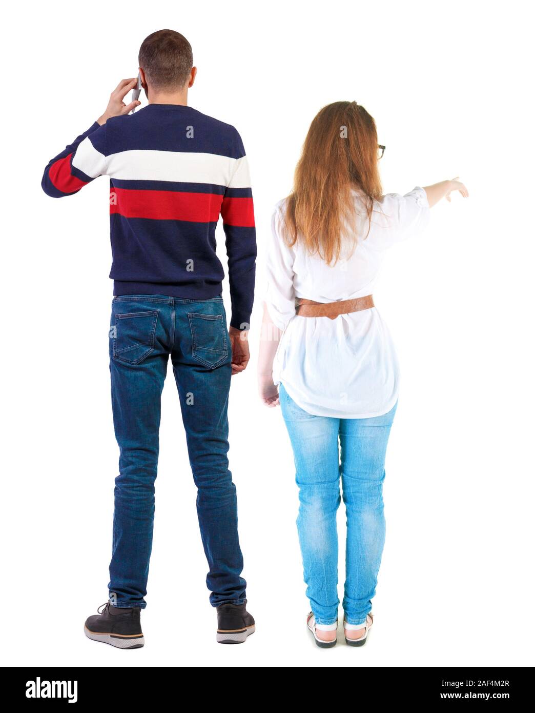 Back view of a stylish couple pointing. beautiful friendly girl and guy ...