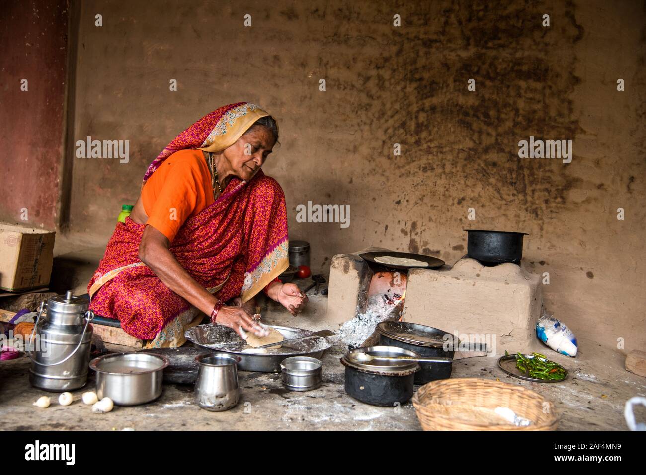 Senior indian woman cooking in pot hi-res stock photography and images ...