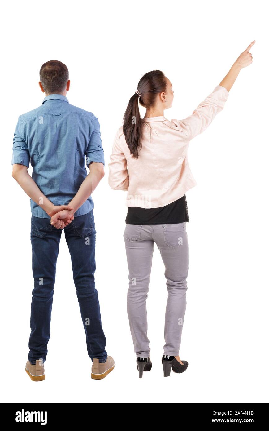 Back view of a stylish couple pointing. beautiful friendly girl and guy ...