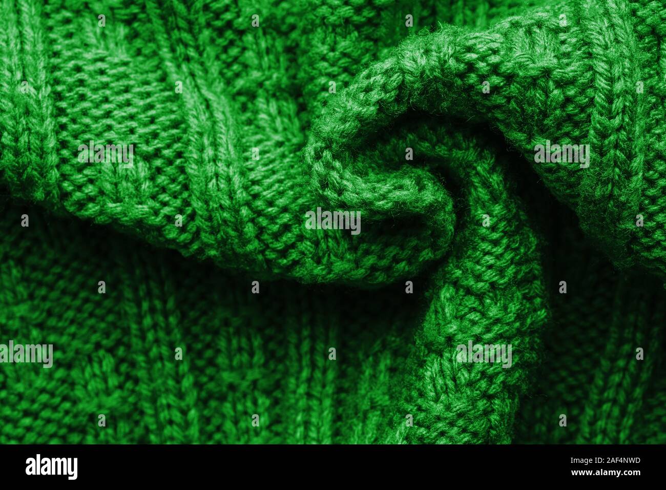 Knitted Sweater Background Twisted into a Spiral. Green mottled pattern ...
