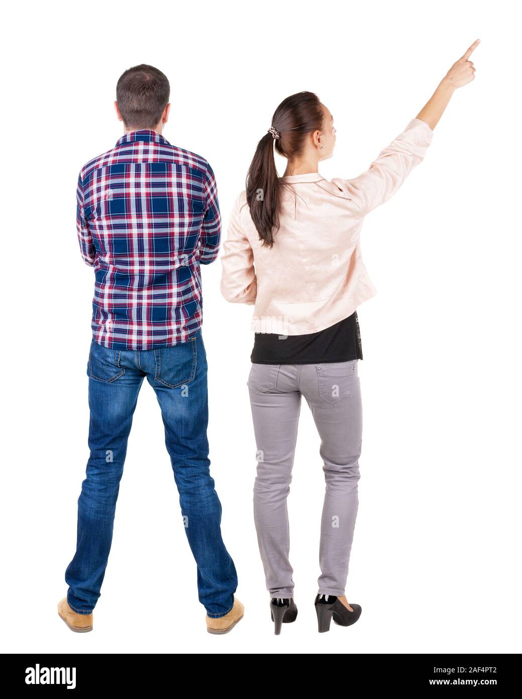Back view of a stylish couple pointing. beautiful friendly girl and guy ...
