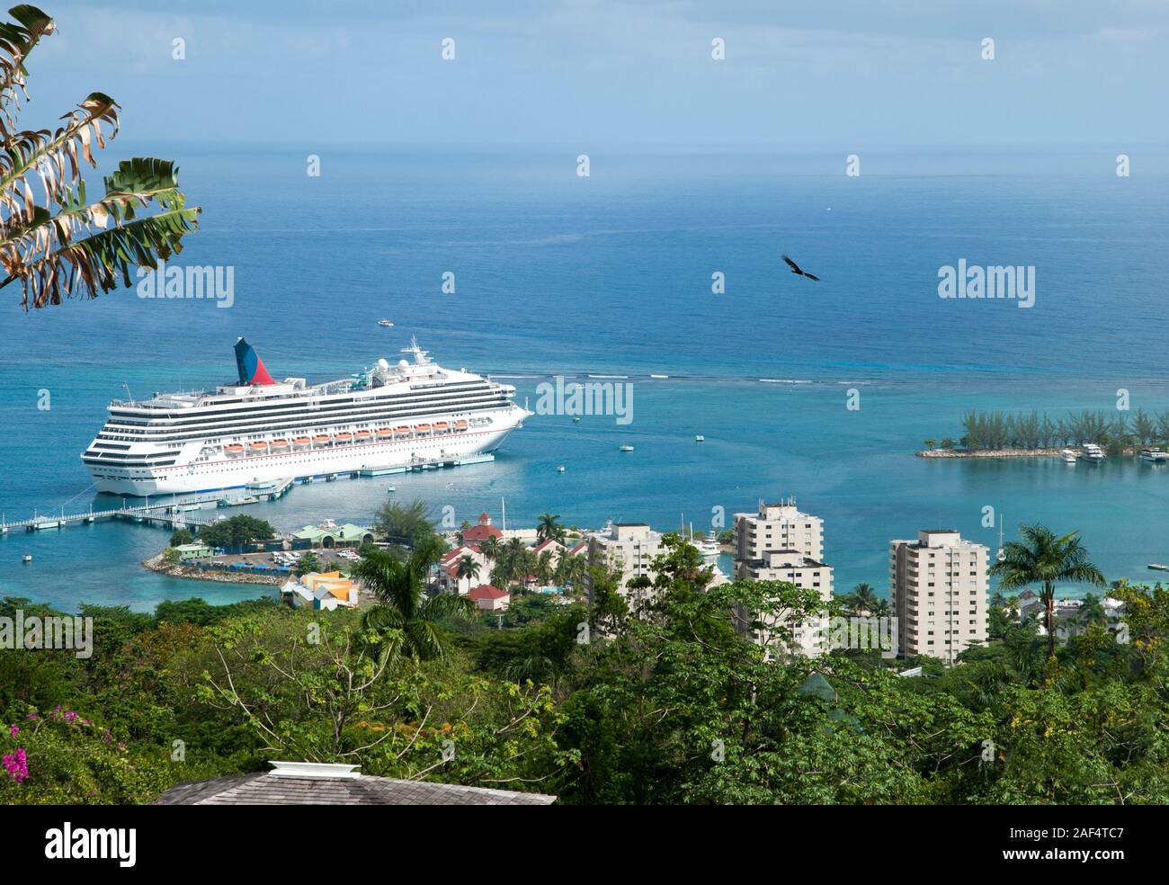 The aerial view of a cruise ship moored in Ocho Rios resort town bay ...